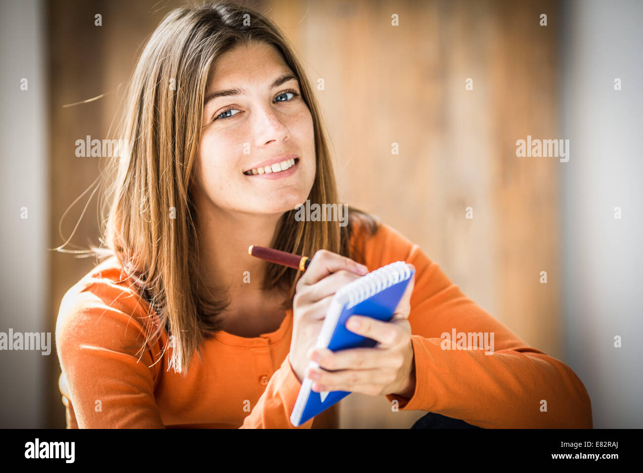 Woman writing in a notebook Stock Photo - Alamy