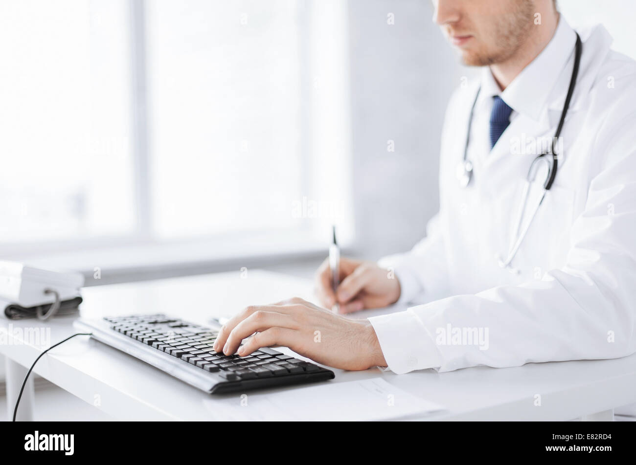 male doctor typing on the keyboard Stock Photo - Alamy