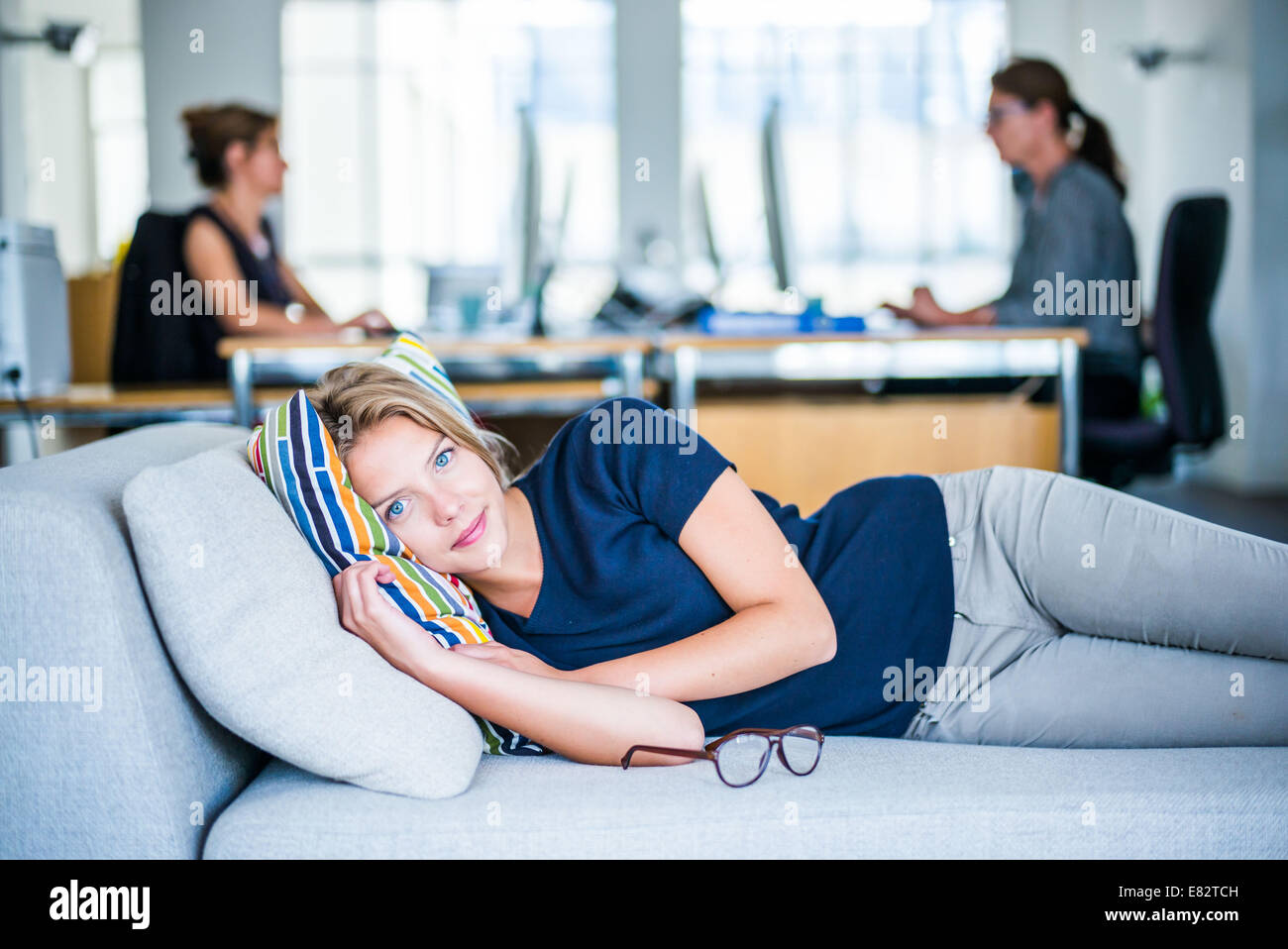 Woman taking a nap in the office Stock Photo - Alamy
