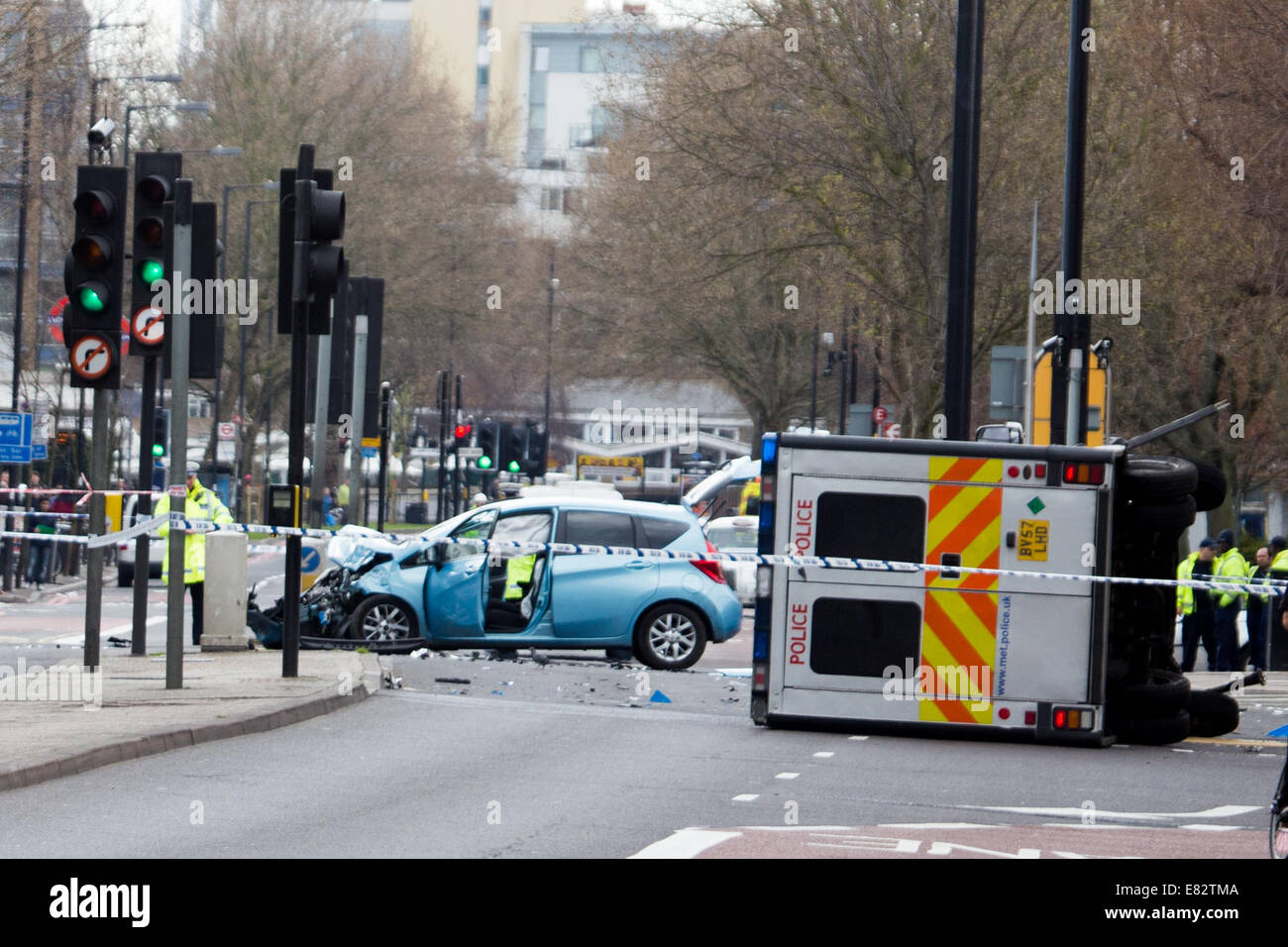 A police riot van flips over on its side after crashing into a ...