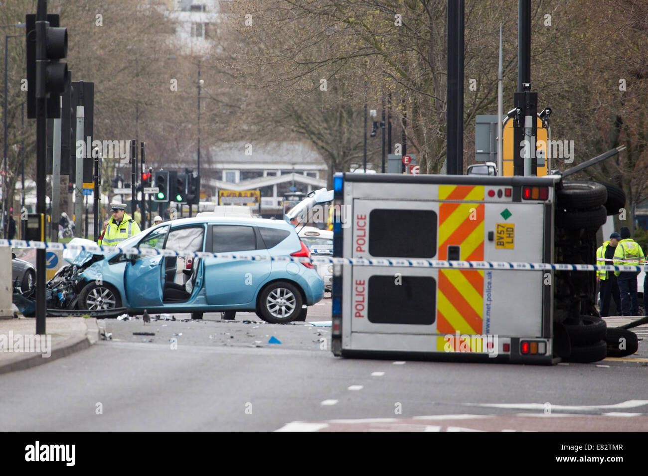 A police riot van flips over on its side after crashing into a ...