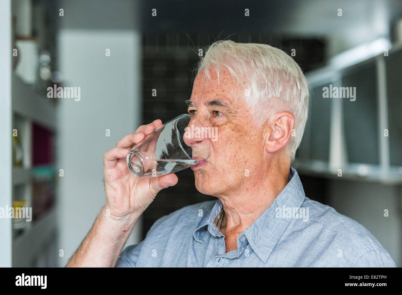 Man drinking glass of water Stock Photo - Alamy