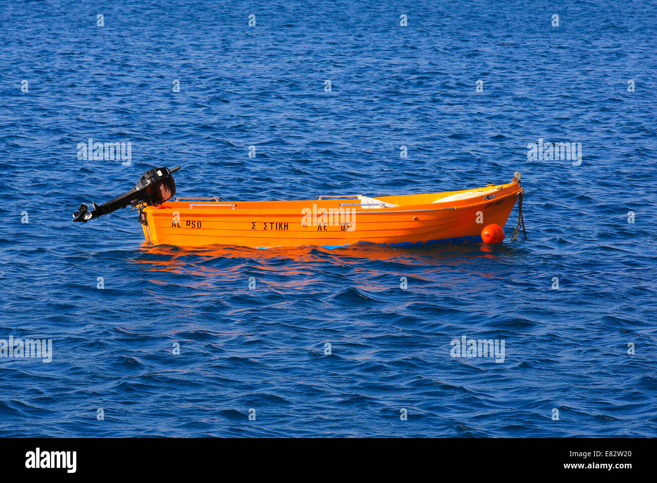 Orange boat in a blue sea Stock Photo - Alamy