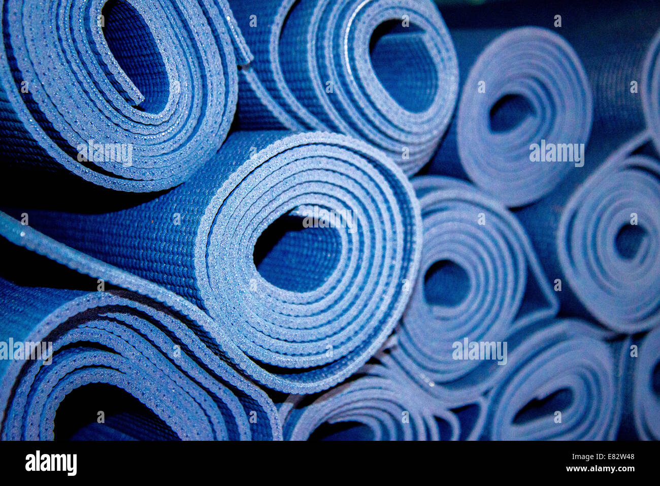 gym equipment for exercise, rolled yoga mats Stock Photo - Alamy