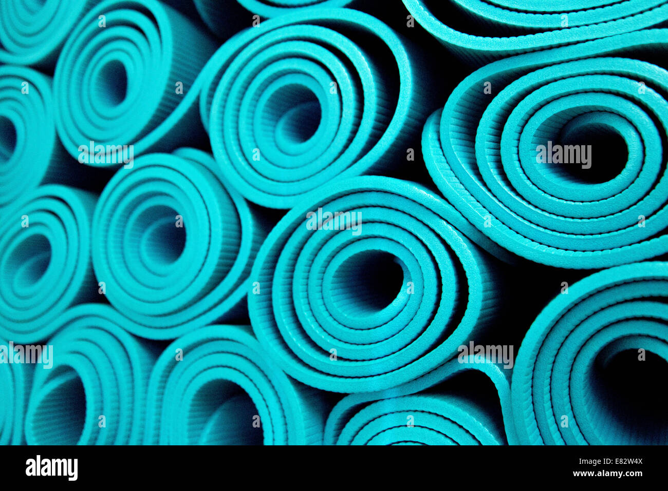 gym equipment for exercise, rolled yoga mats Stock Photo - Alamy