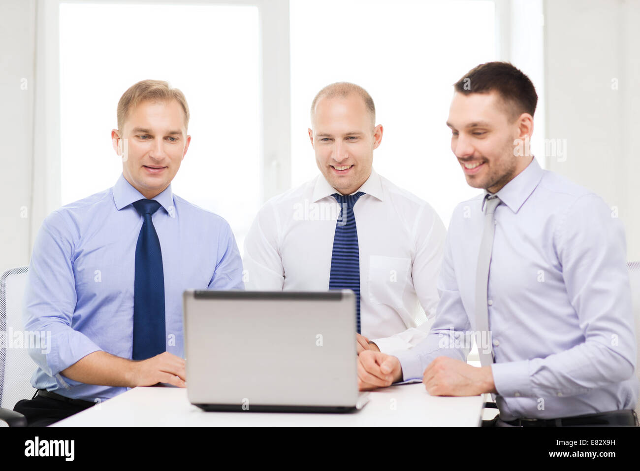 business team working with laptop in office Stock Photo - Alamy