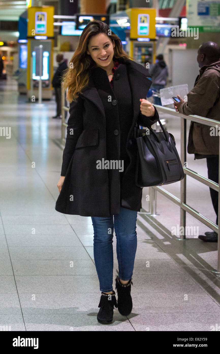 Newly engaged Kelly Brook is all smiles as she arrives solo at John F ...