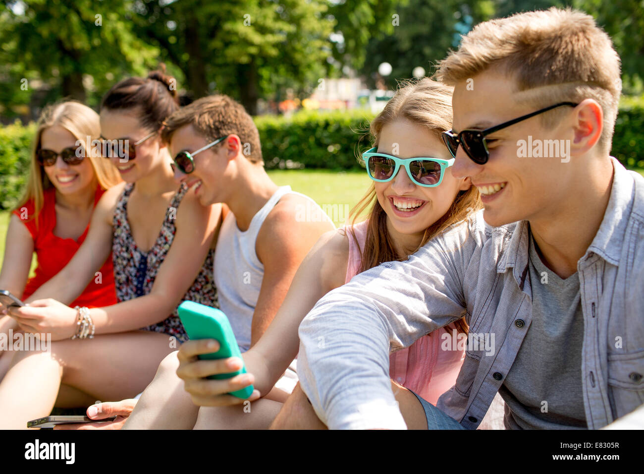 smiling friends with smartphone making selfie Stock Photo - Alamy