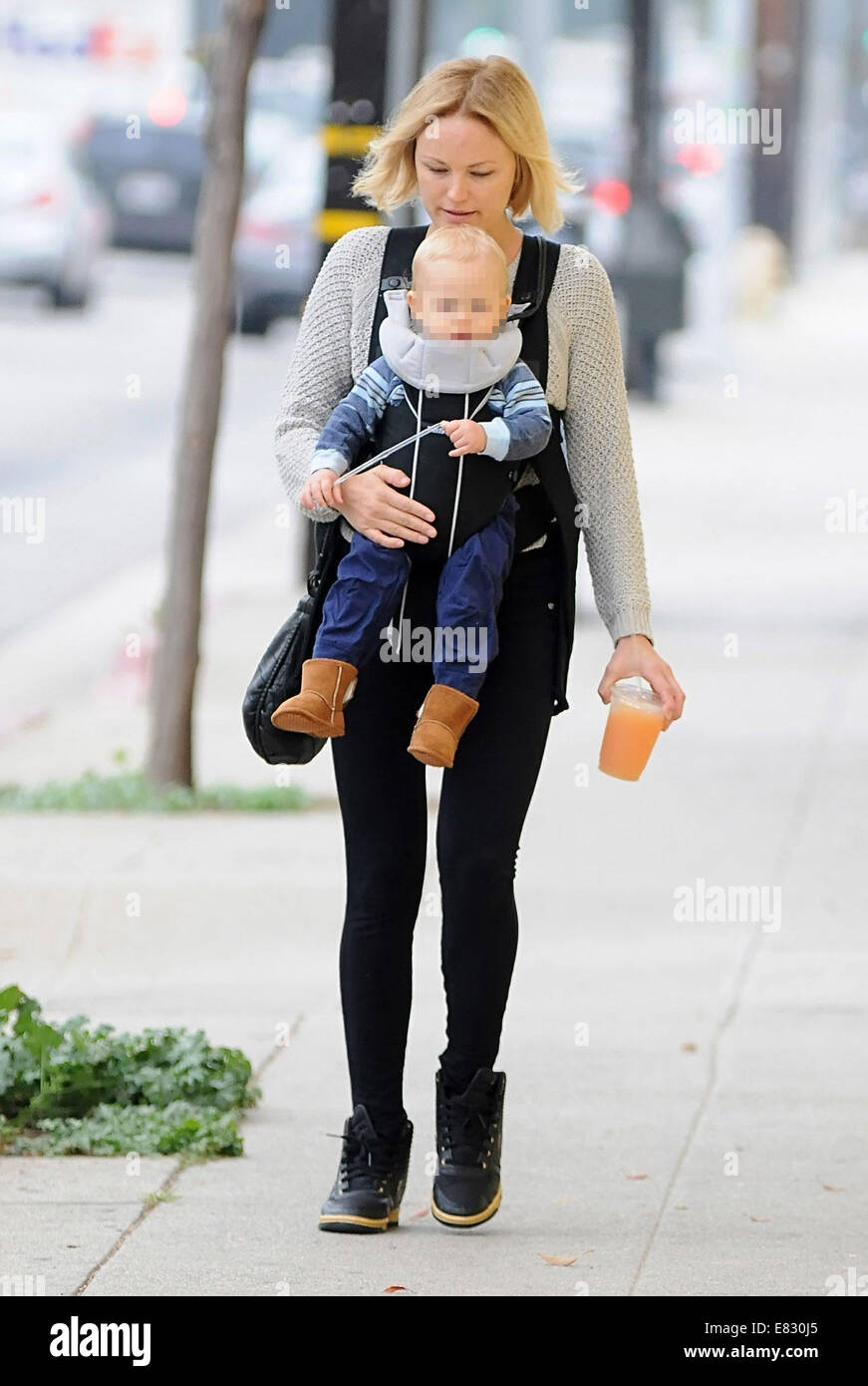 Malin Akerman out and about with son Sebastian, being carried in a ...