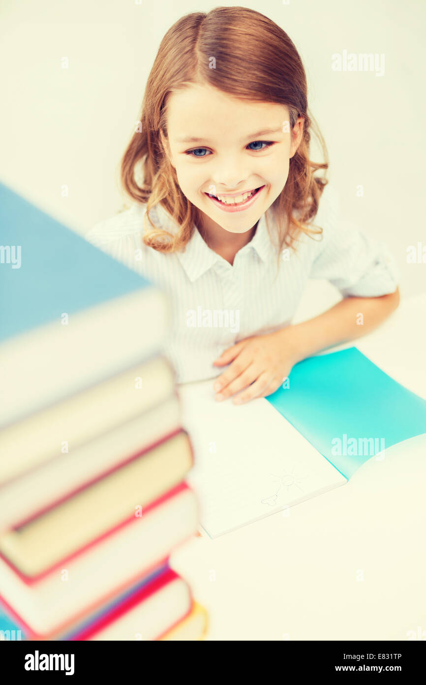 smiling little student girl with many books Stock Photo - Alamy