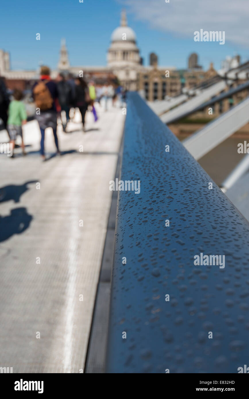Rain drops on the railing of the Millennium Bridge after a rain shower ...