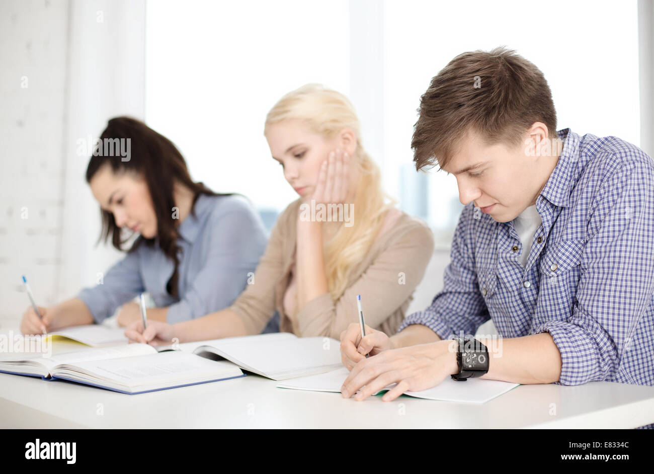 tired students with notebooks at school Stock Photo - Alamy