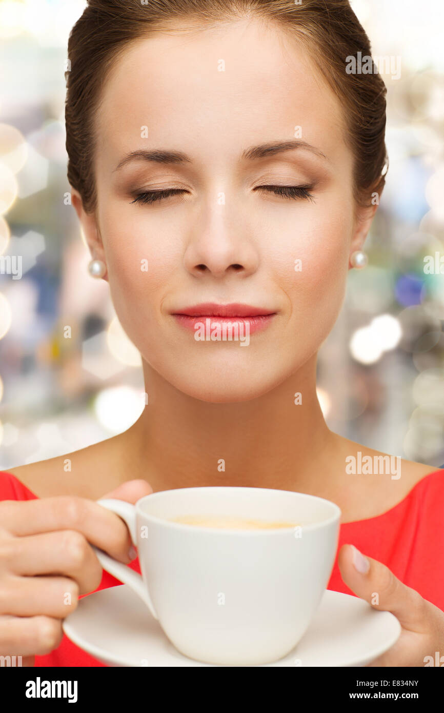 smiling woman in red dress with cup of coffee Stock Photo - Alamy