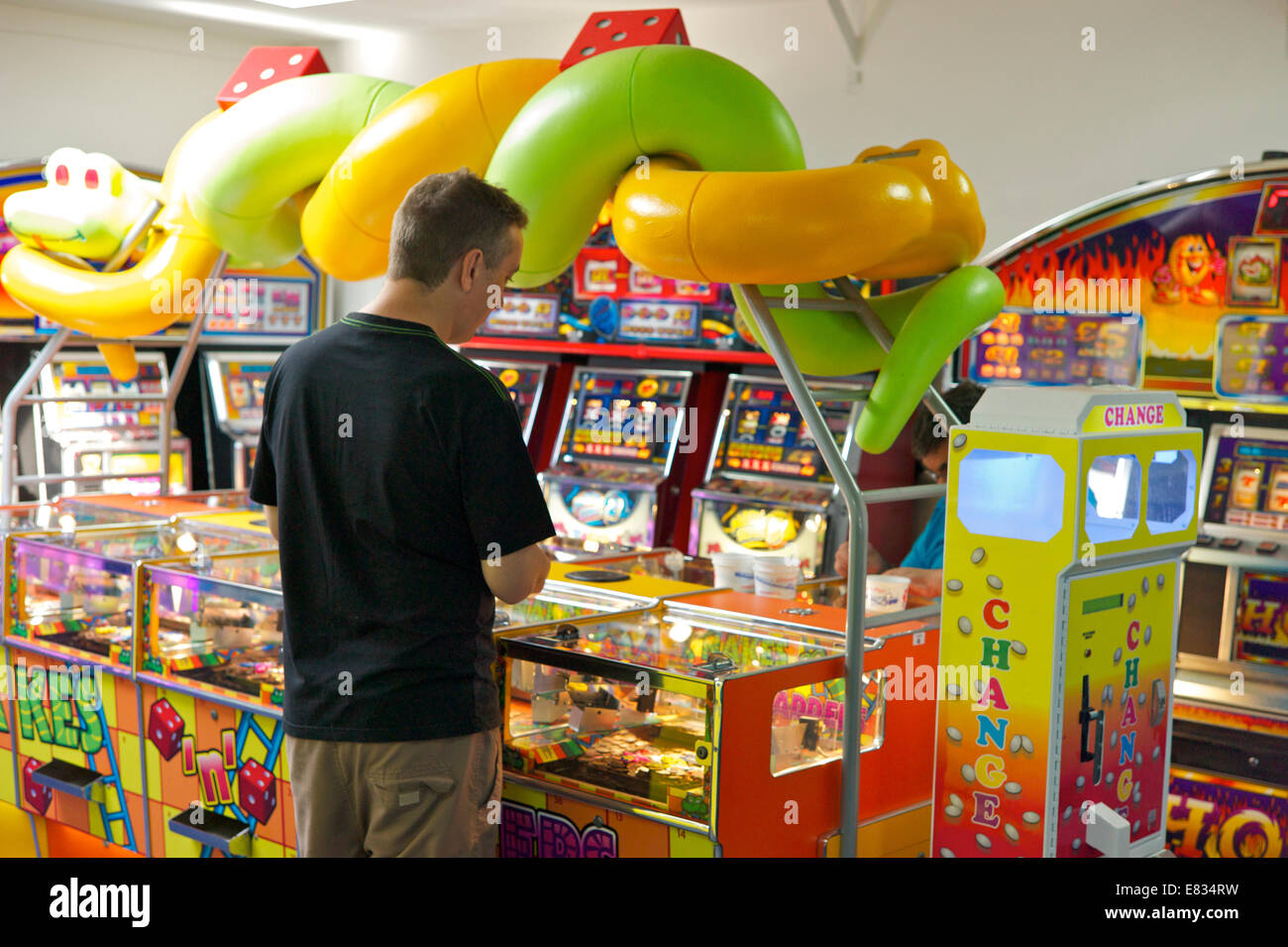Playing the slot machines at an amusement arcade, UK Stock Photo - Alamy