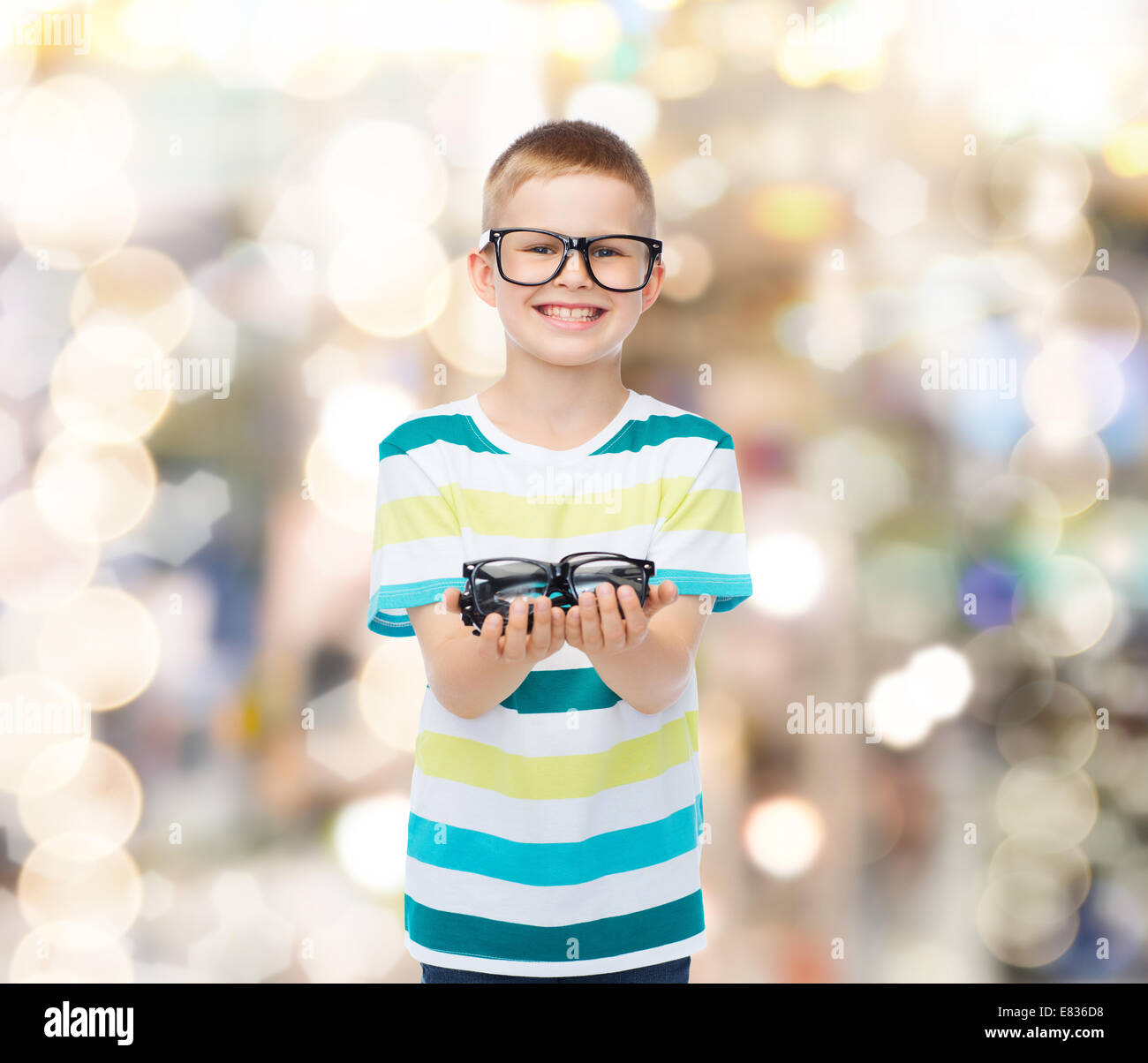 smiling boy in eyeglasses holding spectacles Stock Photo - Alamy