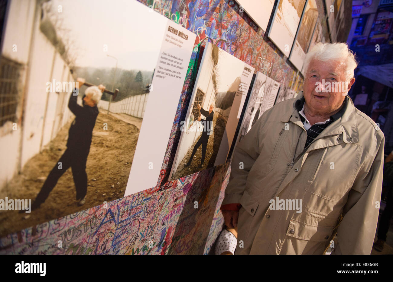 Bernd Mueller pose sin front of a picture which shows him at the Berlin ...