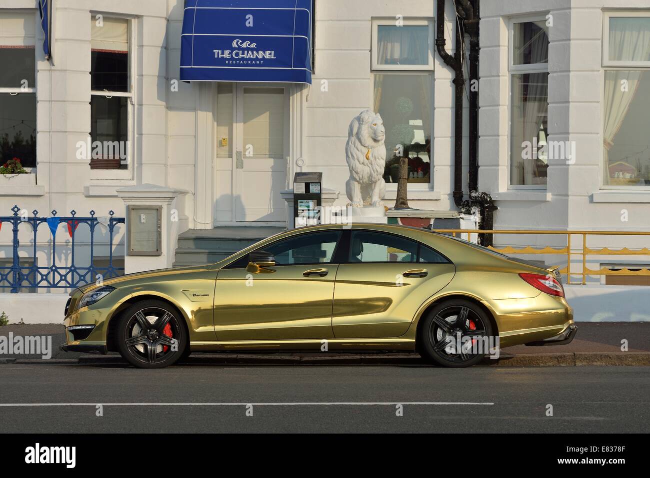 Gold painted Mercedes Benz sports sedan parked on Eastbourne seafront ...