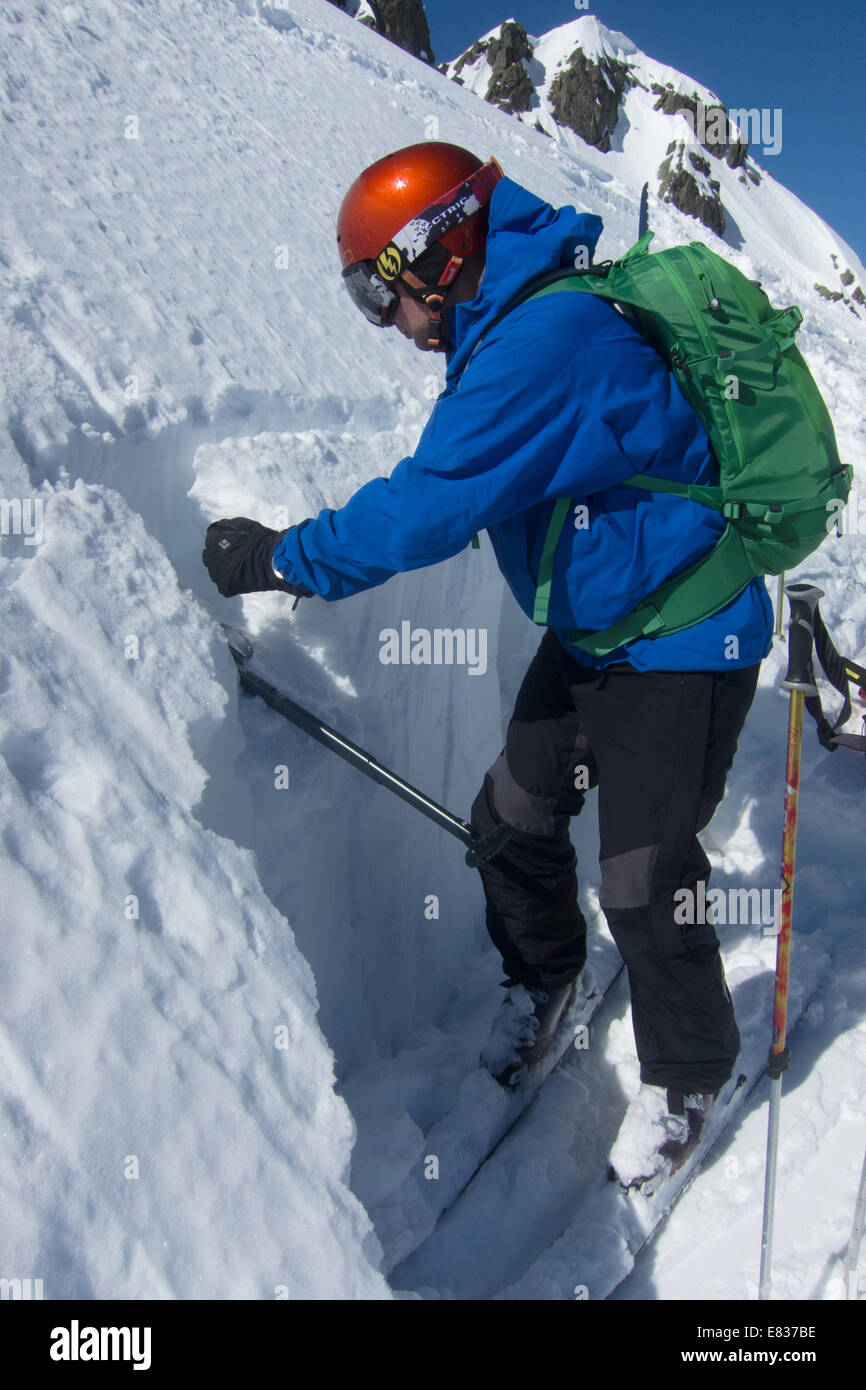 Skier performing an extended column test in a snow pit (snow analysis ...
