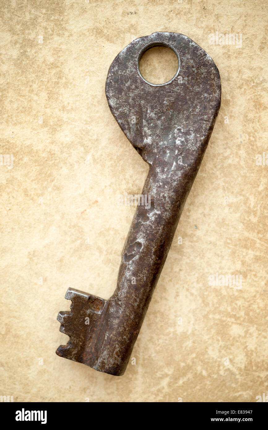 ancient rusty key on vintage cardboard background Stock Photo - Alamy