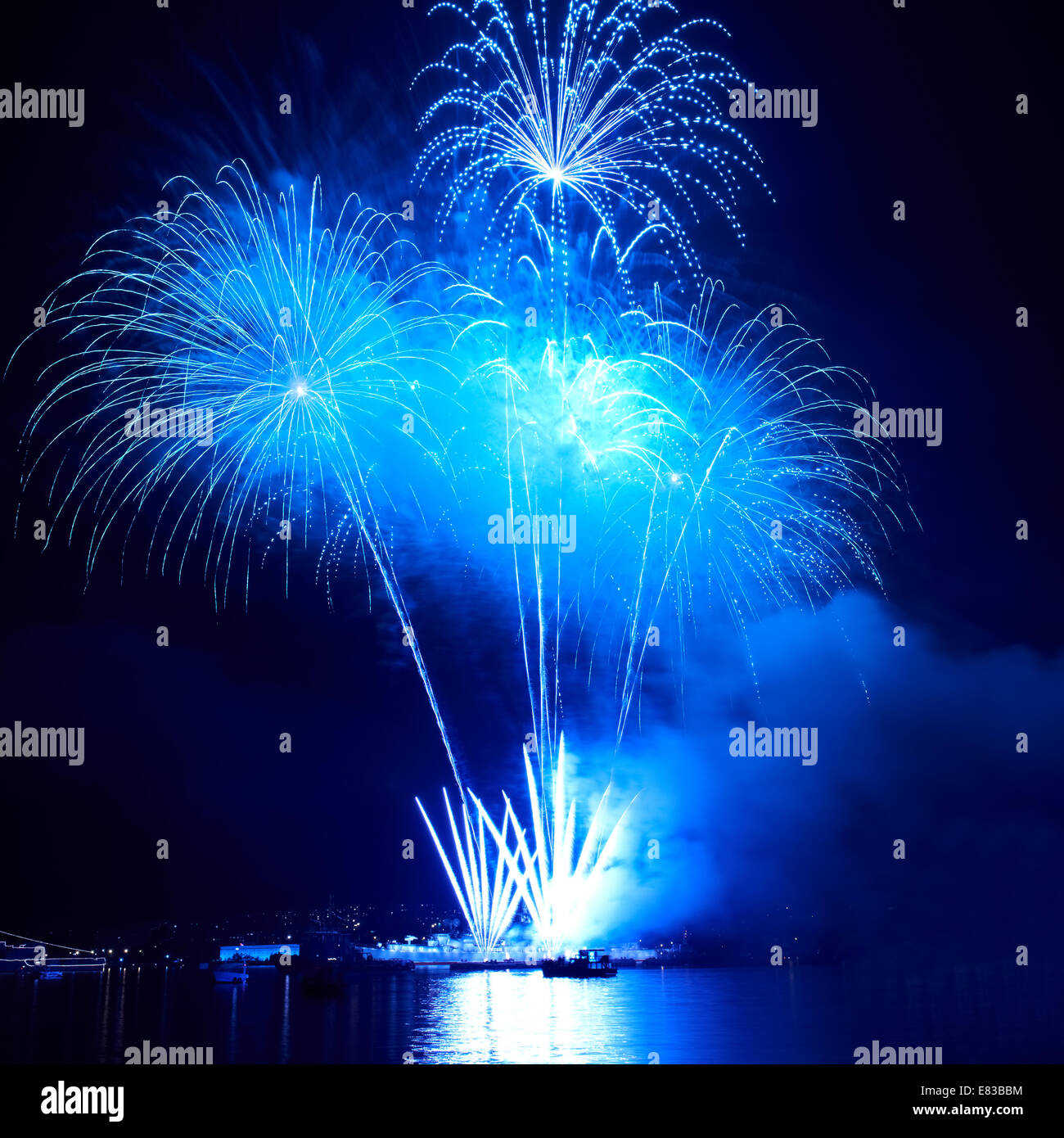 Blue colorful fireworks on the black sky background Stock Photo - Alamy