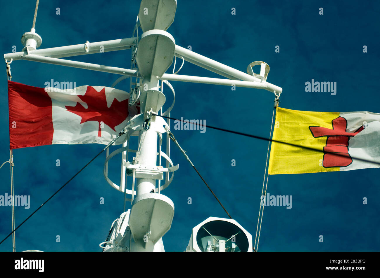 Aboard ship in northern Arctic waters the flags of Canada and the ...