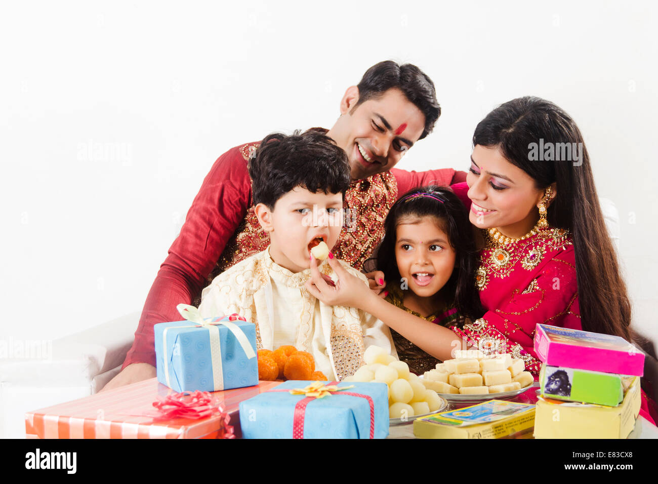 Indian man eating sweet hi-res stock photography and images - Alamy
