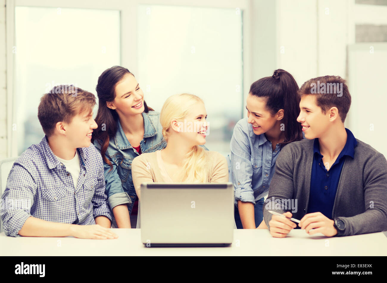 smiling students with laptop at school Stock Photo - Alamy