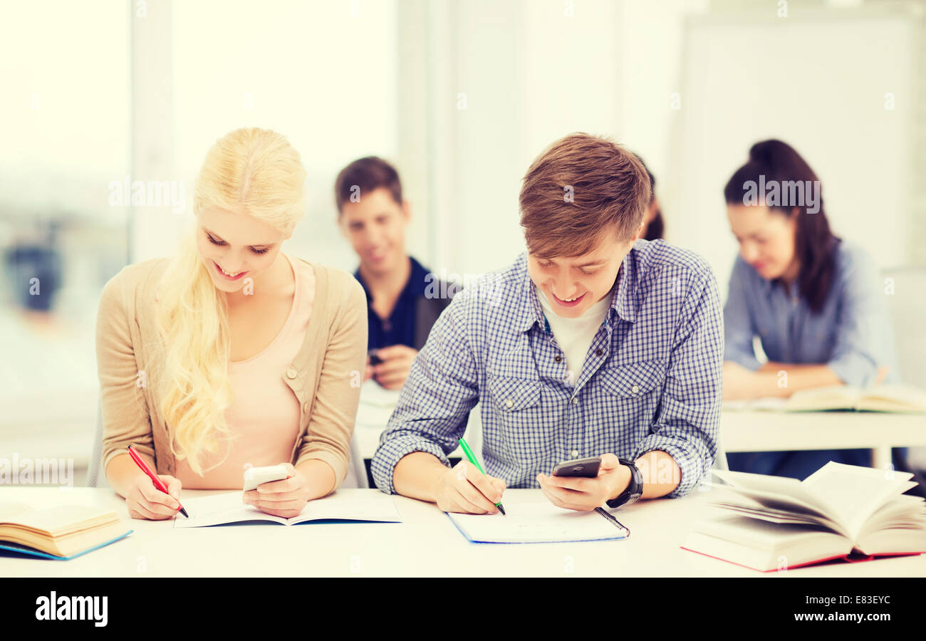 students looking into smartphone at school Stock Photo - Alamy