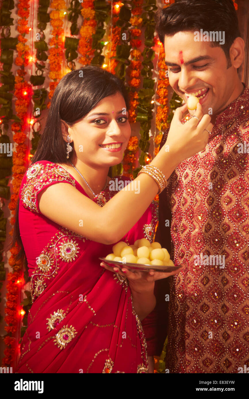 Indian man eating sweet hi-res stock photography and images - Alamy