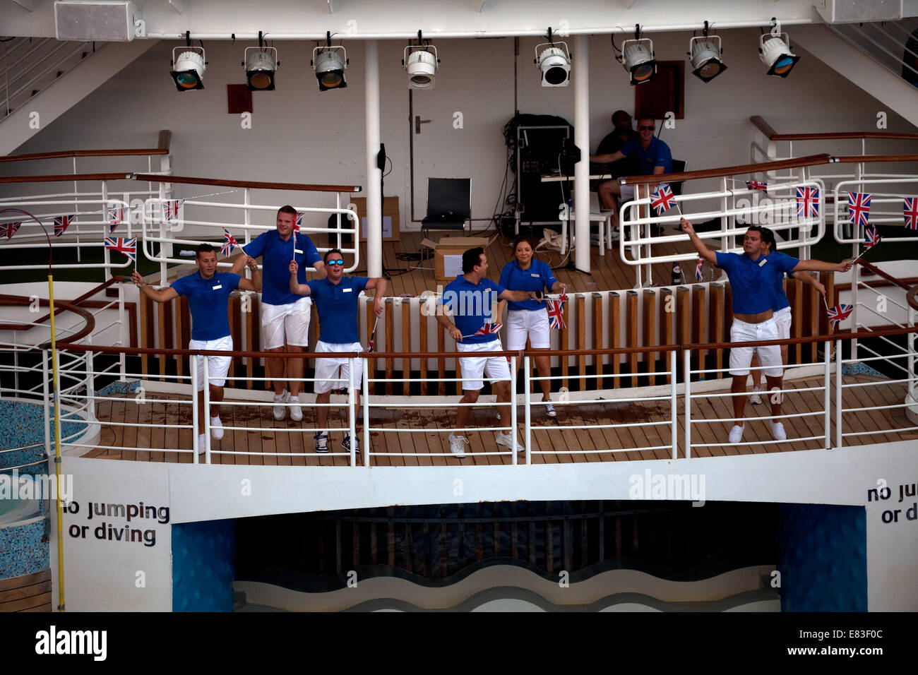 Crew members lead the on board celebrations, with flag waving,dancing ...