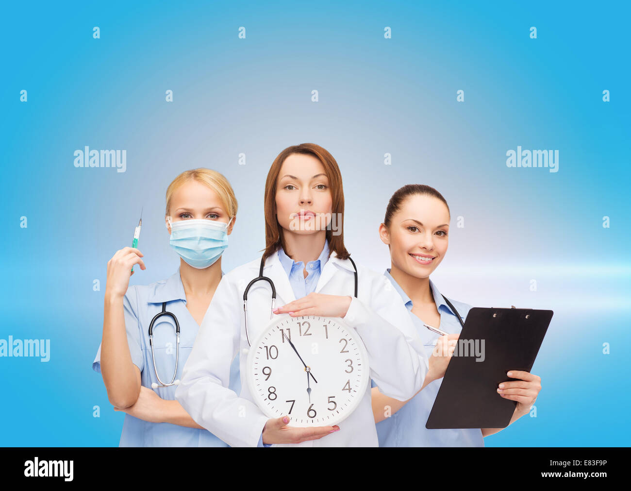 calm female doctor and nurses with wall clock Stock Photo - Alamy