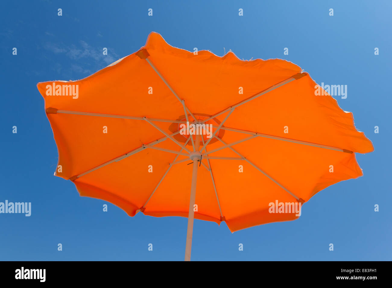 Orange parasol against a blue sky Stock Photo - Alamy