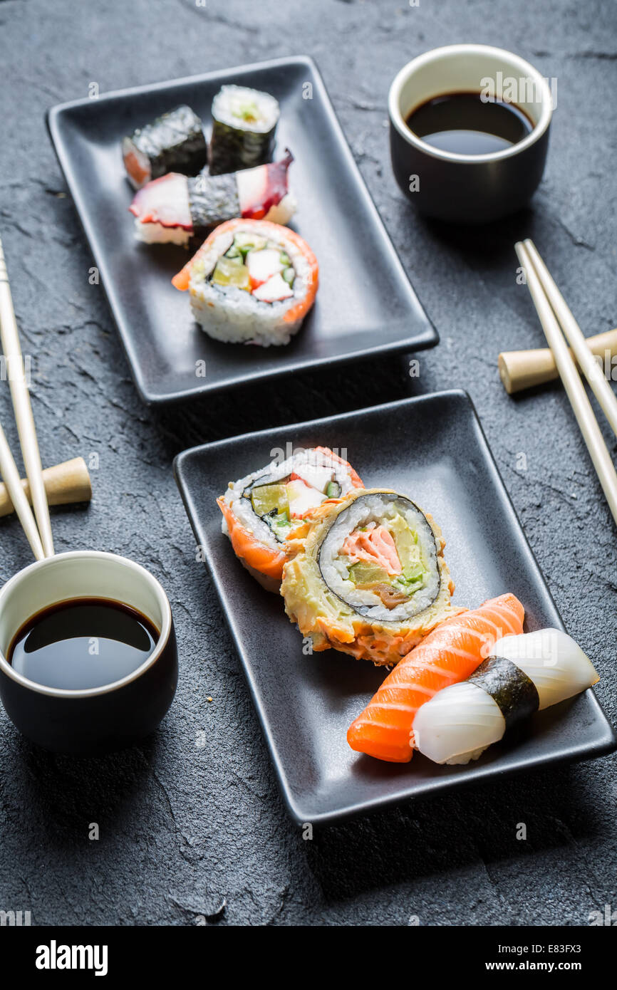 Sushi for two served in a black ceramic Stock Photo - Alamy