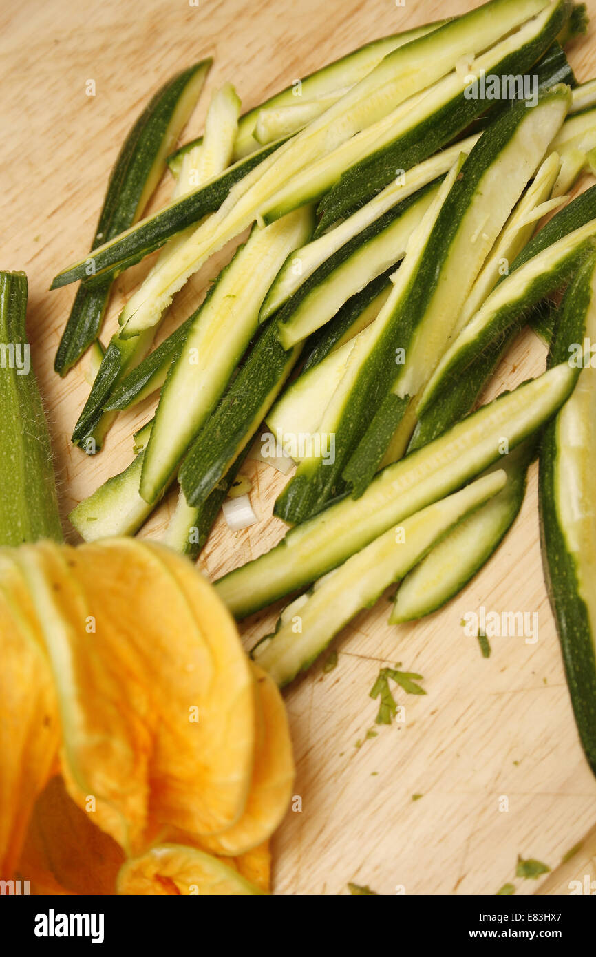 sliced courgettes with flowers attached on chopping board Cucurbita ...