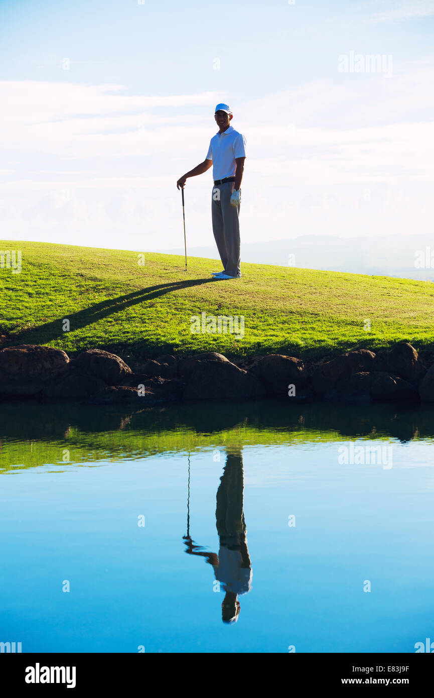 Silhouette of Man Playing Golf on Beautiful Course, Reflection in Water ...