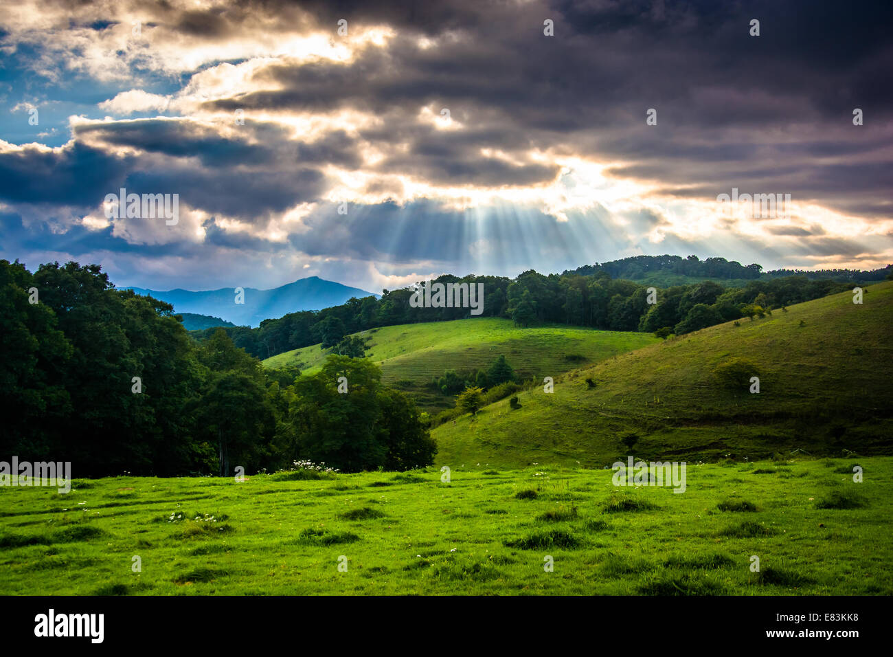 Crepuscular rays over a field and rolling hills at Moses Cone Park on ...