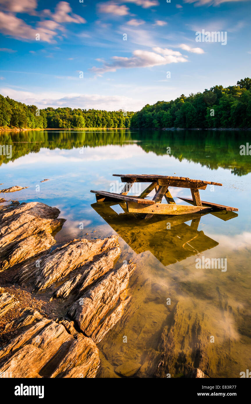 Rocks and a picnic table in Lake Marburg, at Codorus State Park ...