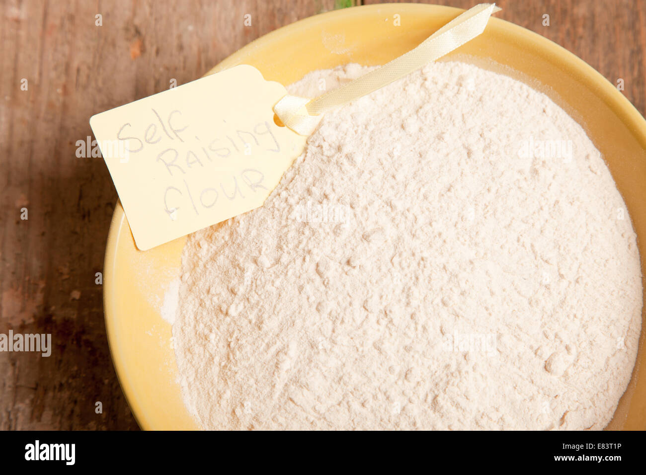 self raising flour in yellow bowl on wooden table Stock Photo - Alamy