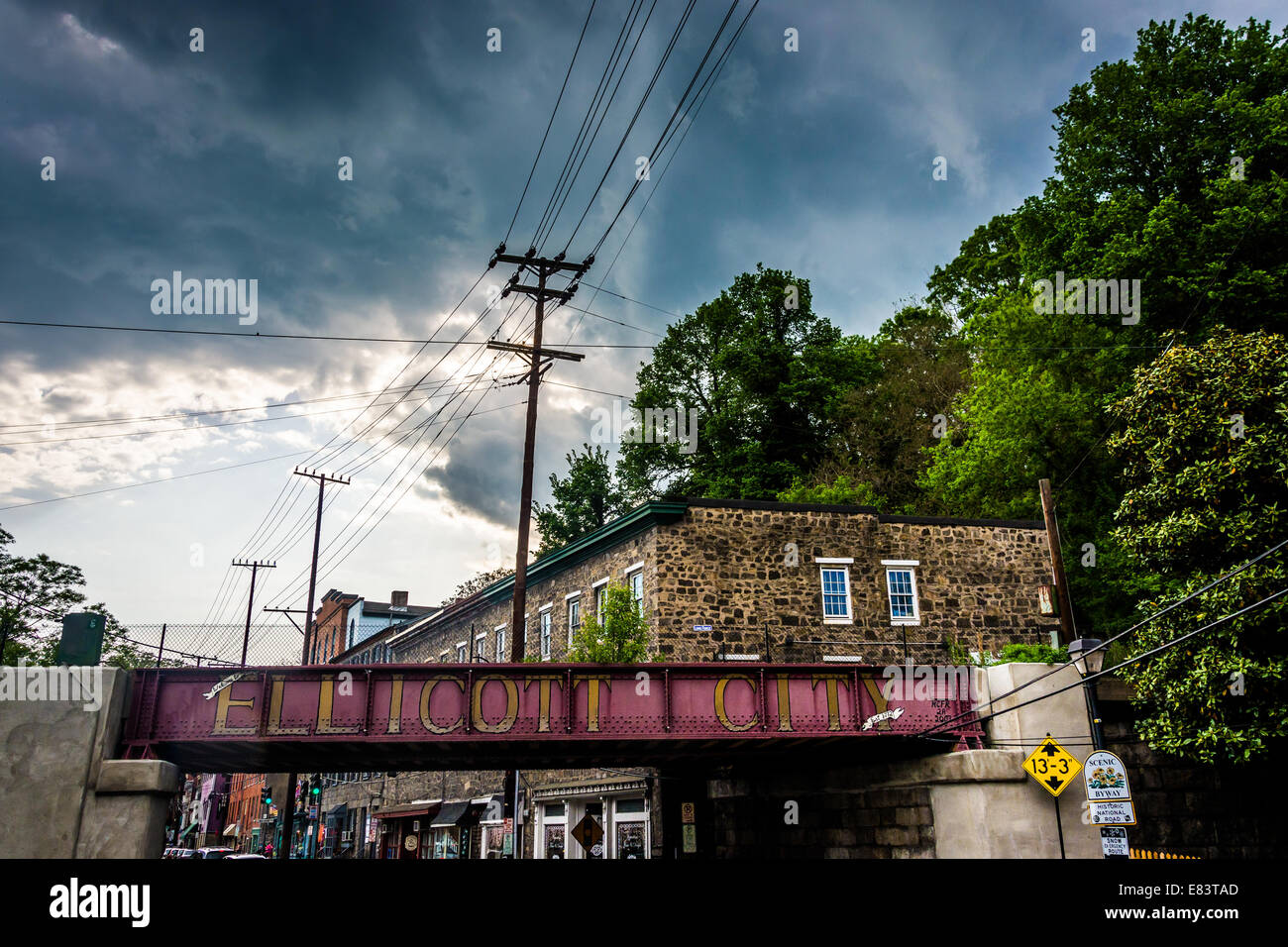 Storm clouds over a railroad bridge and buildings in Ellicott City ...