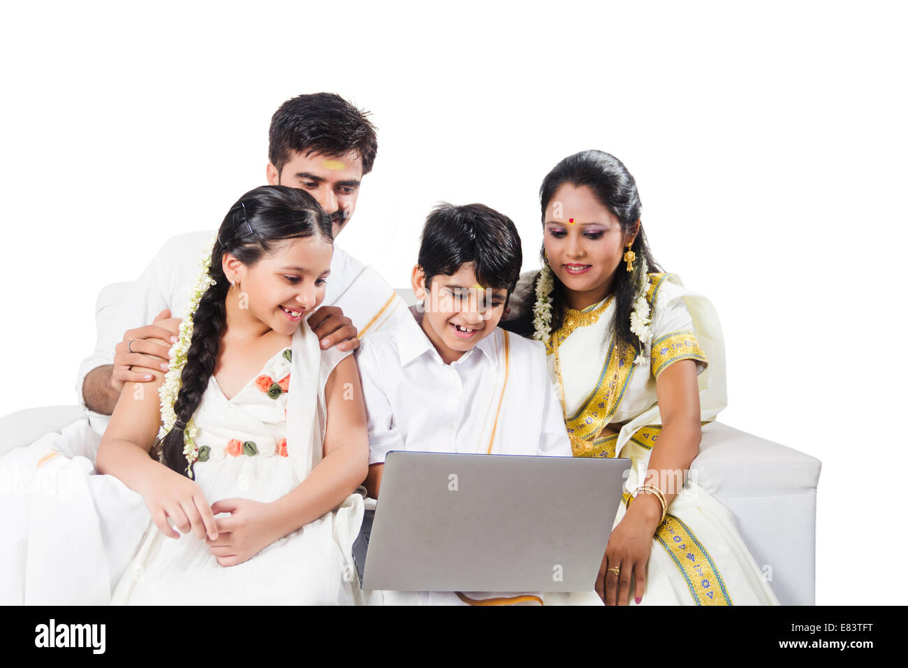 South Indian family sitting with laptop Stock Photo - Alamy