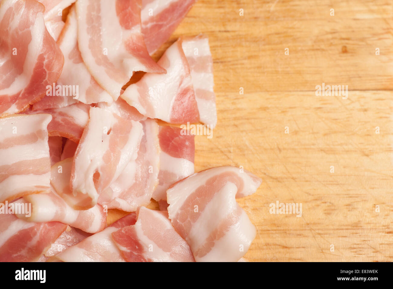 streaky bacon cut in tu chunks on chopping board Stock Photo - Alamy