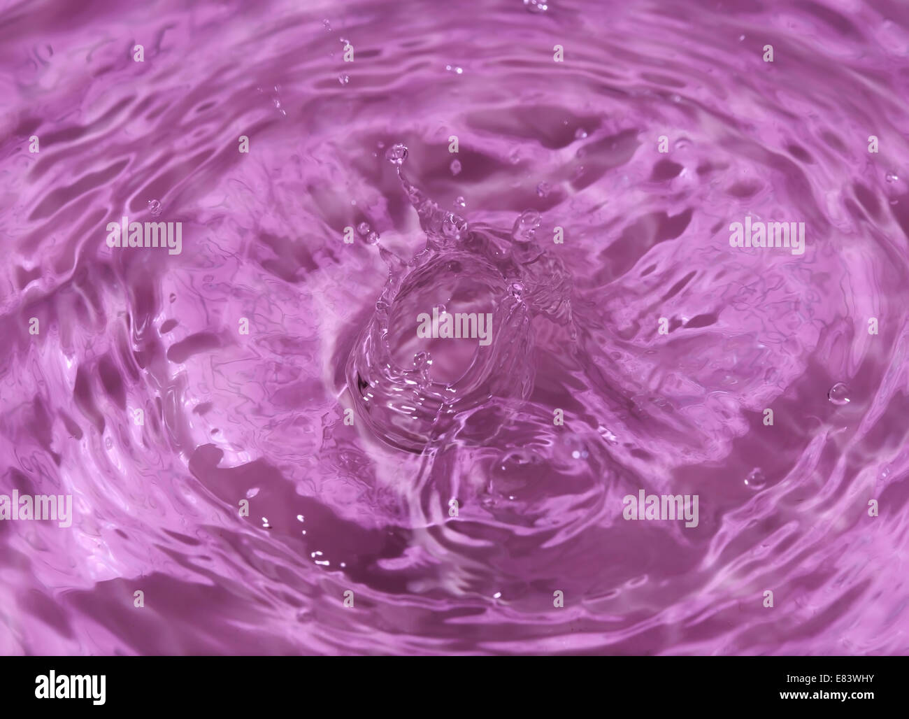 Water splash with a drop of water flying from above Stock Photo - Alamy