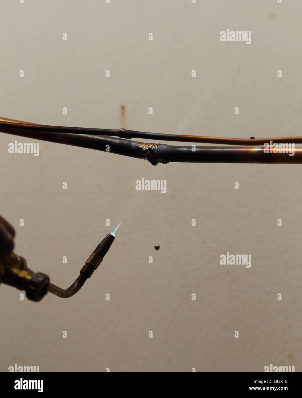 Air conditioner repairman welding copper pipes Stock Photo - Alamy