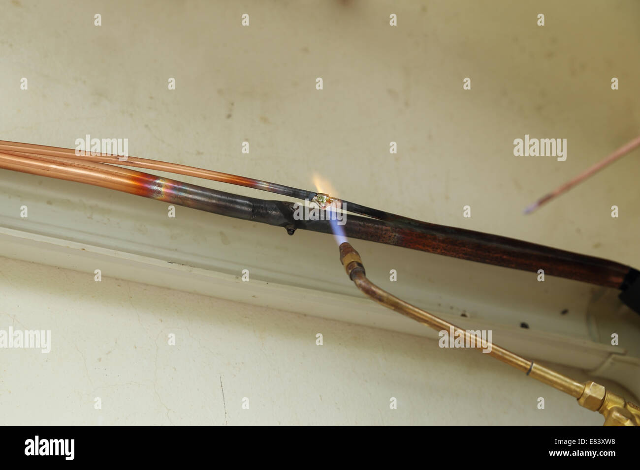 Air conditioner repairman welding copper pipes Stock Photo - Alamy
