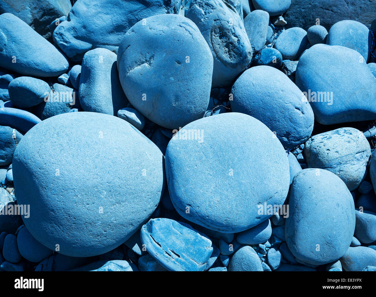 Blue toned zen rocks smoothed by the ocean Stock Photo - Alamy