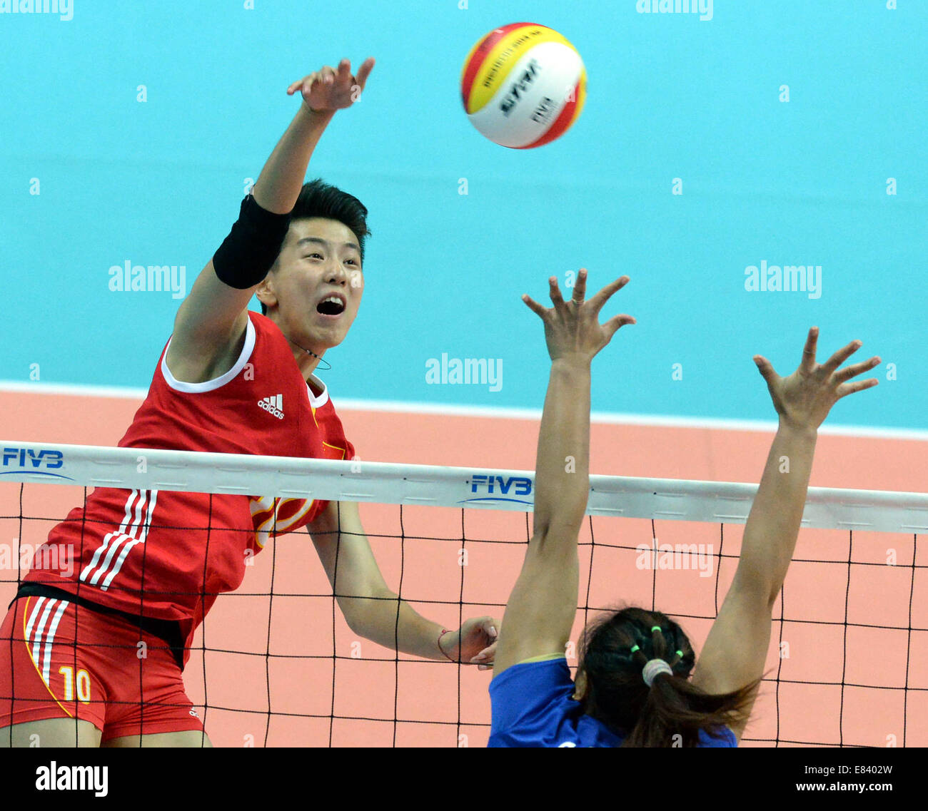 Incheon, South Korea. 30th Sep, 2014. Zhang Xiaoya (L) of China spikes ...