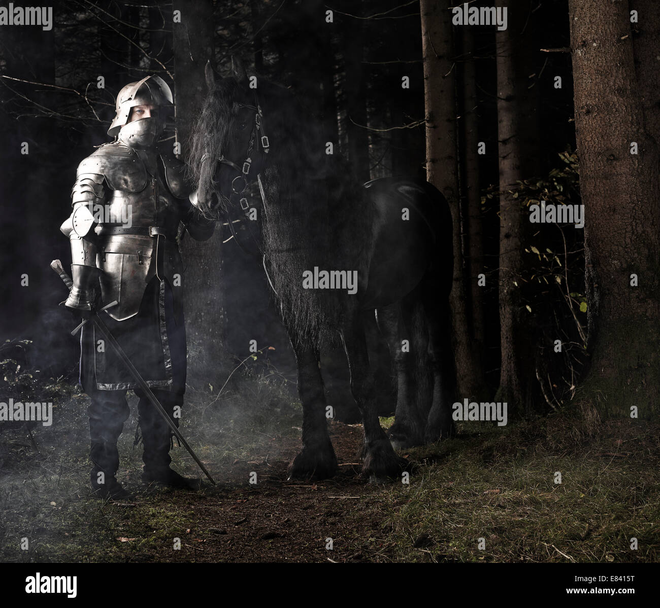 Knight wearing armour standing beside his horse in the woods, Tyrol ...