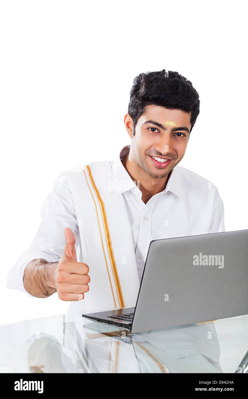 South Indian man working laptop with phone Stock Photo - Alamy