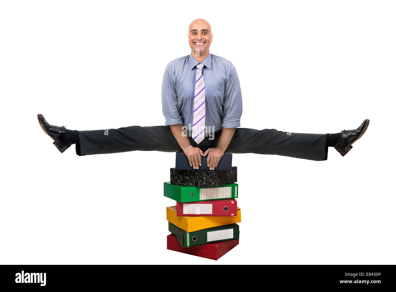 Businessman doing exercises over a stack of files Stock Photo - Alamy