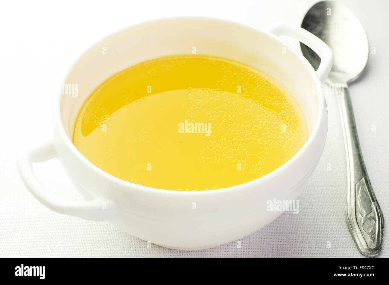 Broth, bouillon in a ceramic bowl. Next vintage spoon Stock Photo - Alamy